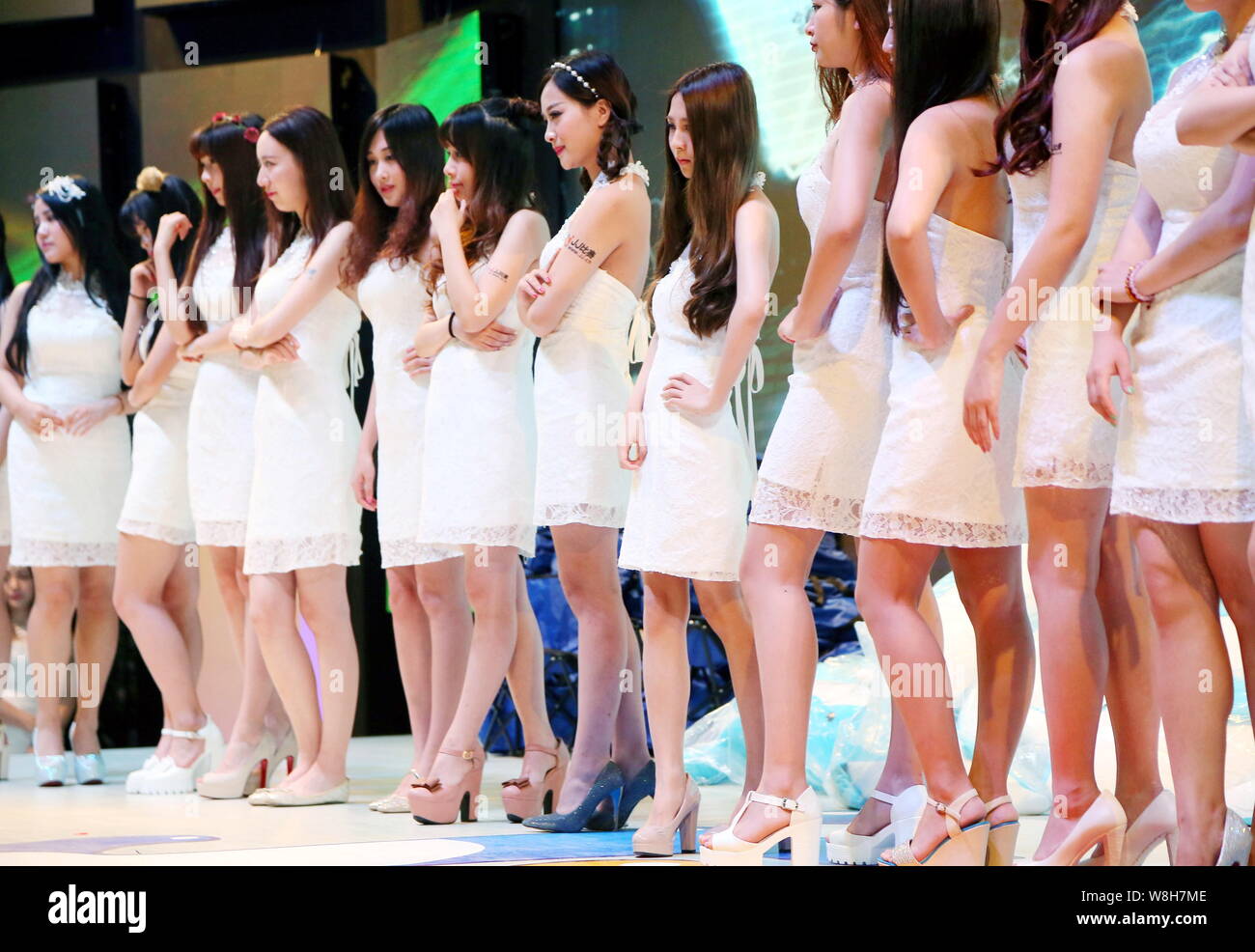 Showgirls pose at the stand of Chinese online game operator jj.cn ...
