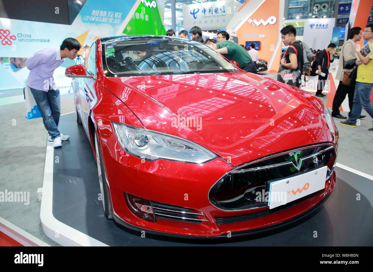 --FILE--Visitors look into a Tesla Model S electric car on display at a ...