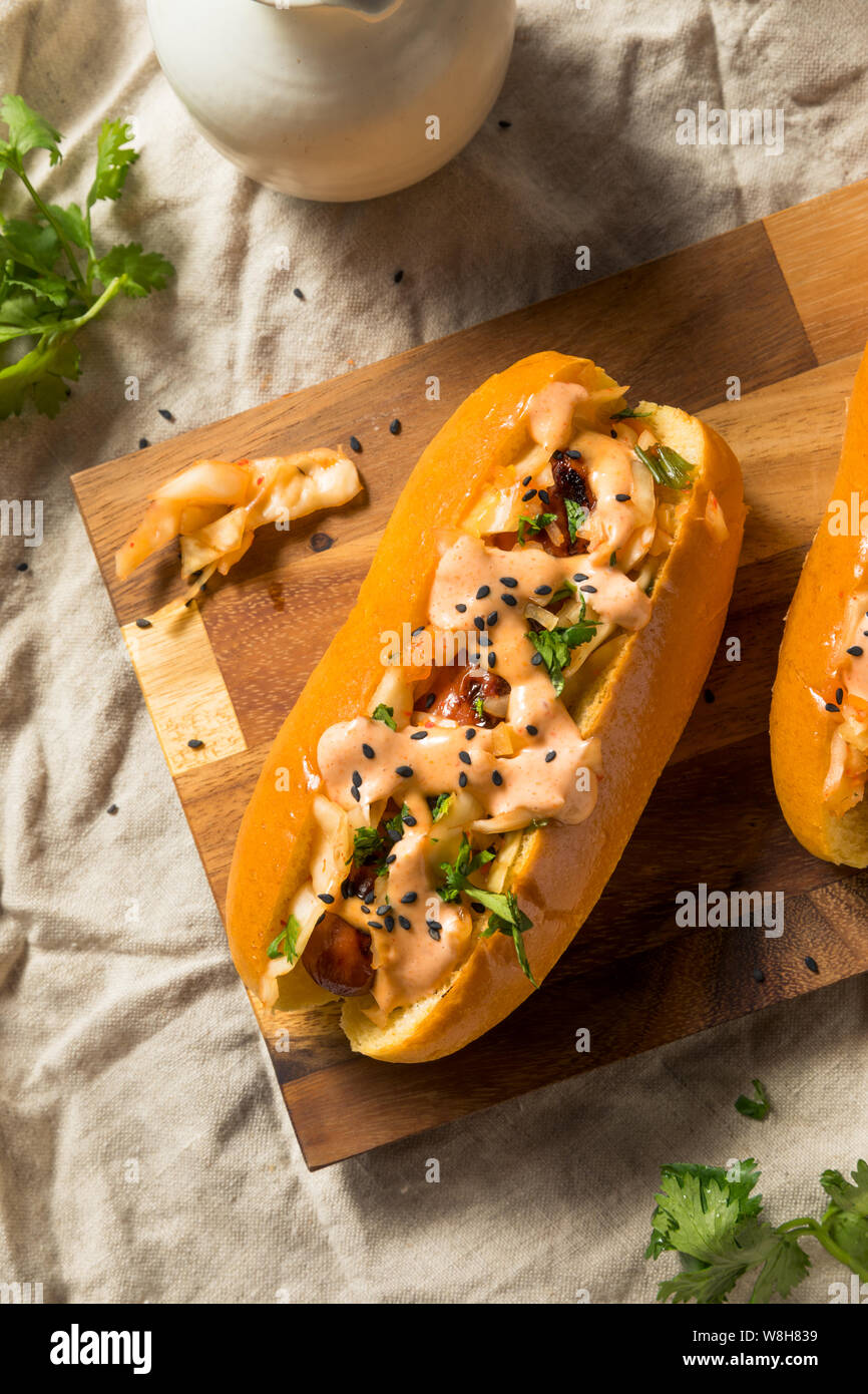 Homemade Korean Kimchi Hot Dogs with Sriracha and Sesame Seeds Stock ...