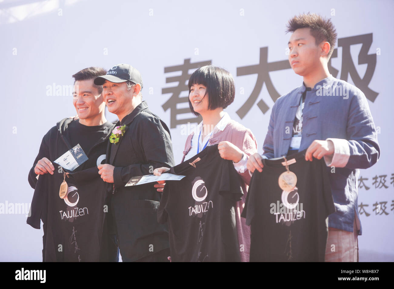 Chinese kungfu star Jet Li, second left, poses at the opening ceremony ...