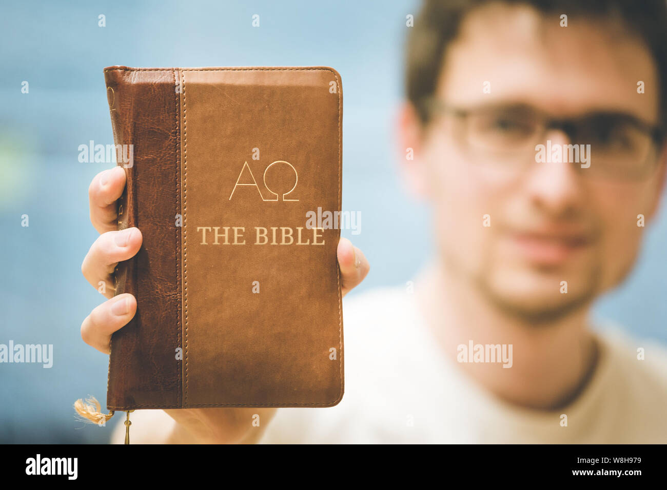 Young preacher is holding the holy bible, praying Stock Photo - Alamy