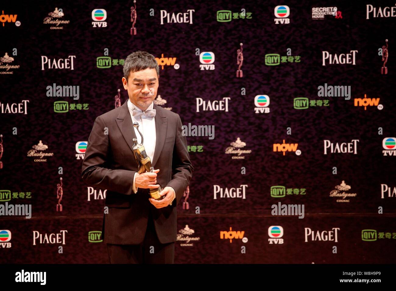 Hong Kong actor Sean Lau poses with the trophy for the Best Actor award ...