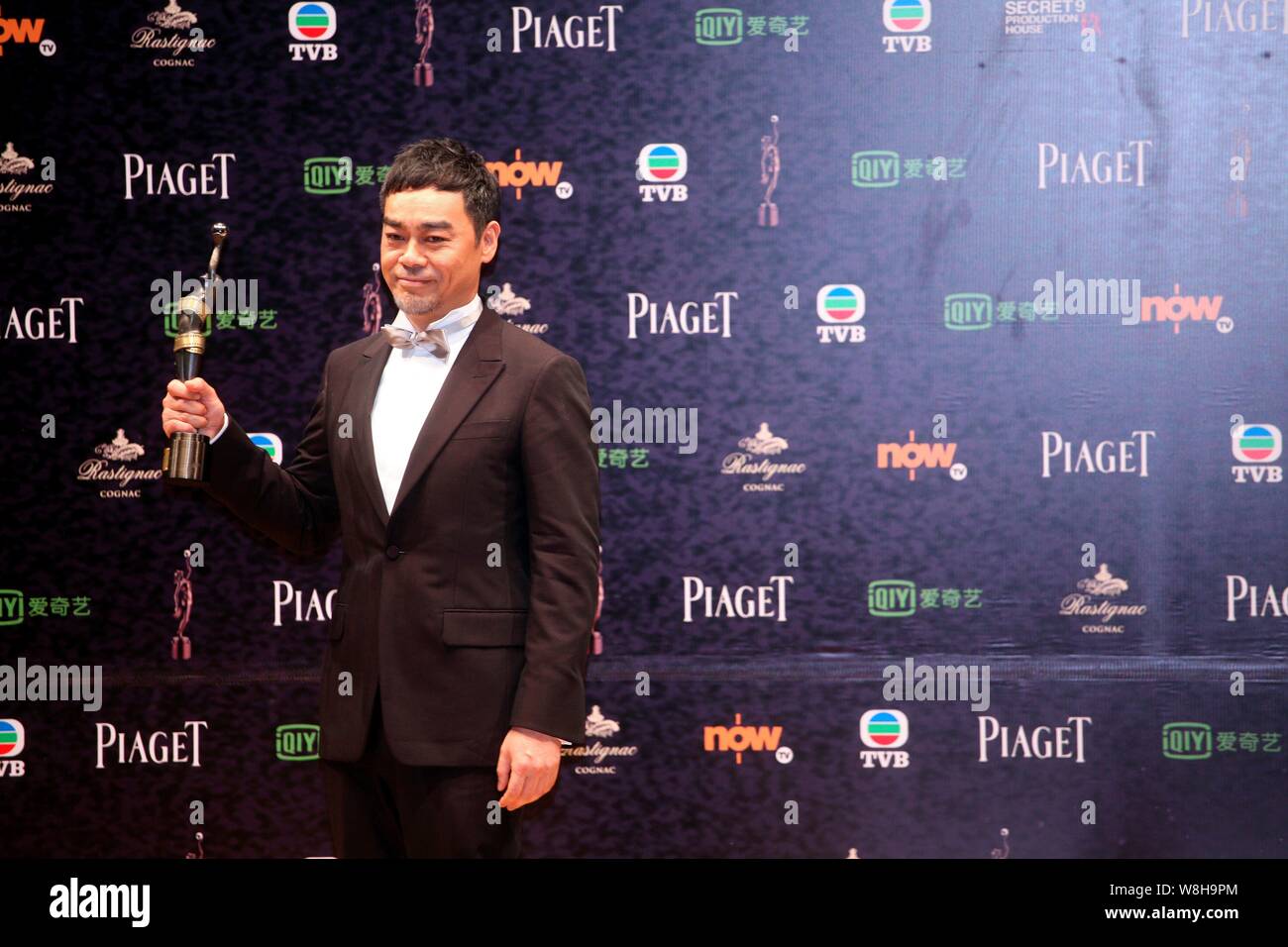 Hong Kong actor Sean Lau poses with the trophy for the Best Actor award ...