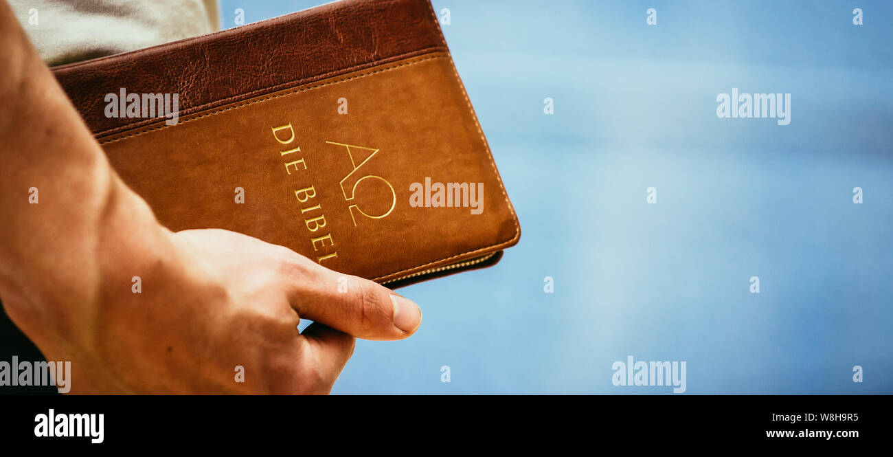 Young preacher is holding the holy bible, praying Stock Photo - Alamy