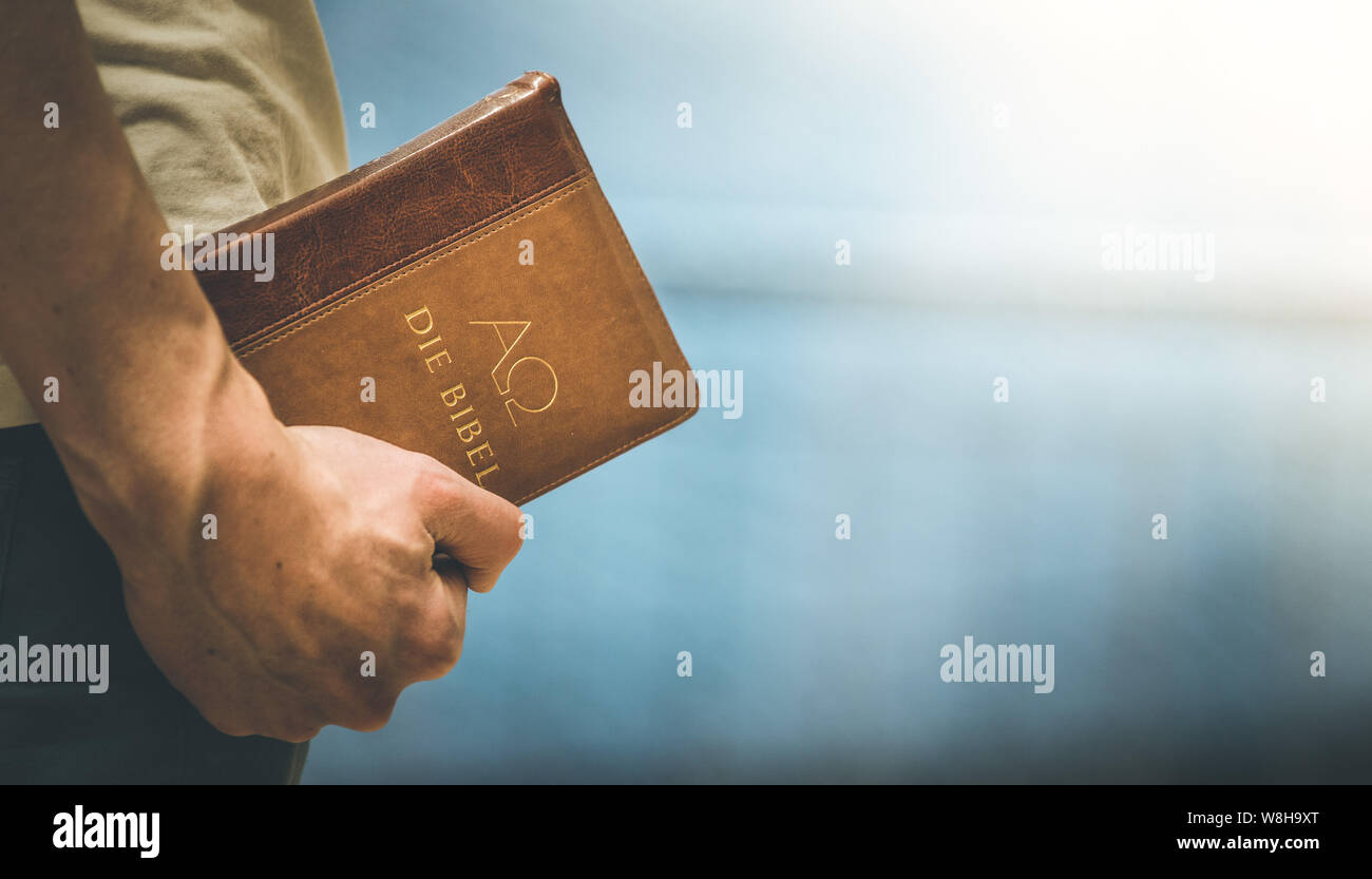 Young preacher is holding the holy bible, praying Stock Photo - Alamy