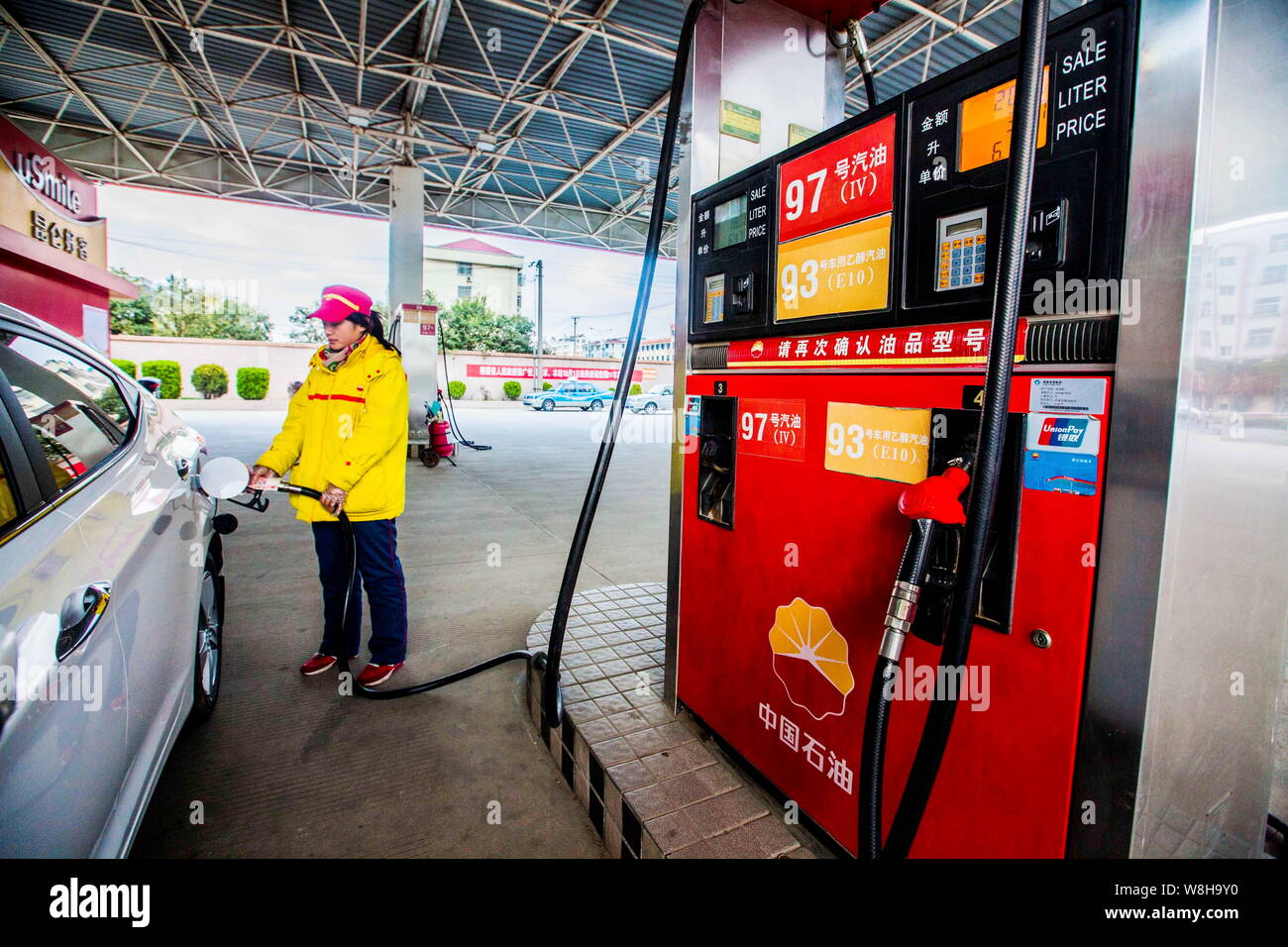 --FILE--A Chinese worker refuels a car at a gas station of PetroChina ...