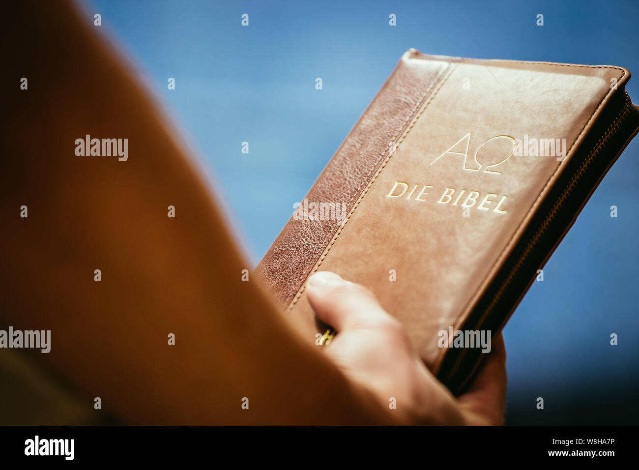 Young preacher is holding the holy bible, praying Stock Photo - Alamy