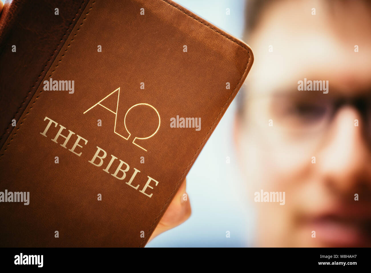 Young preacher is holding the holy bible, praying Stock Photo - Alamy