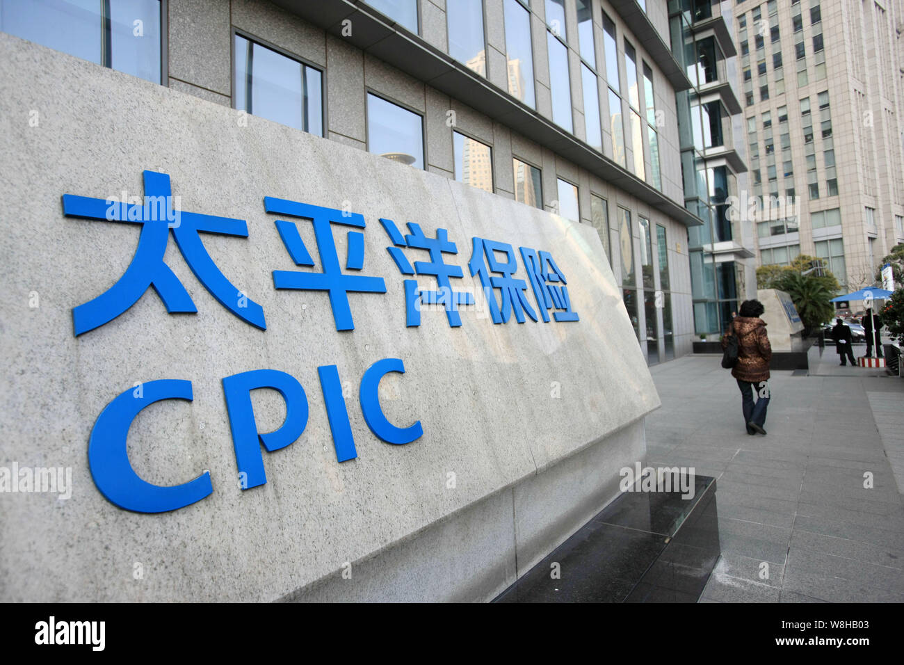 --FILE--A pedestrian is seen in front of an office building of China ...