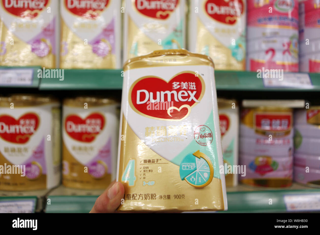 --FILE--A customer buys a tin of Dumex infant formula of Danone at a ...