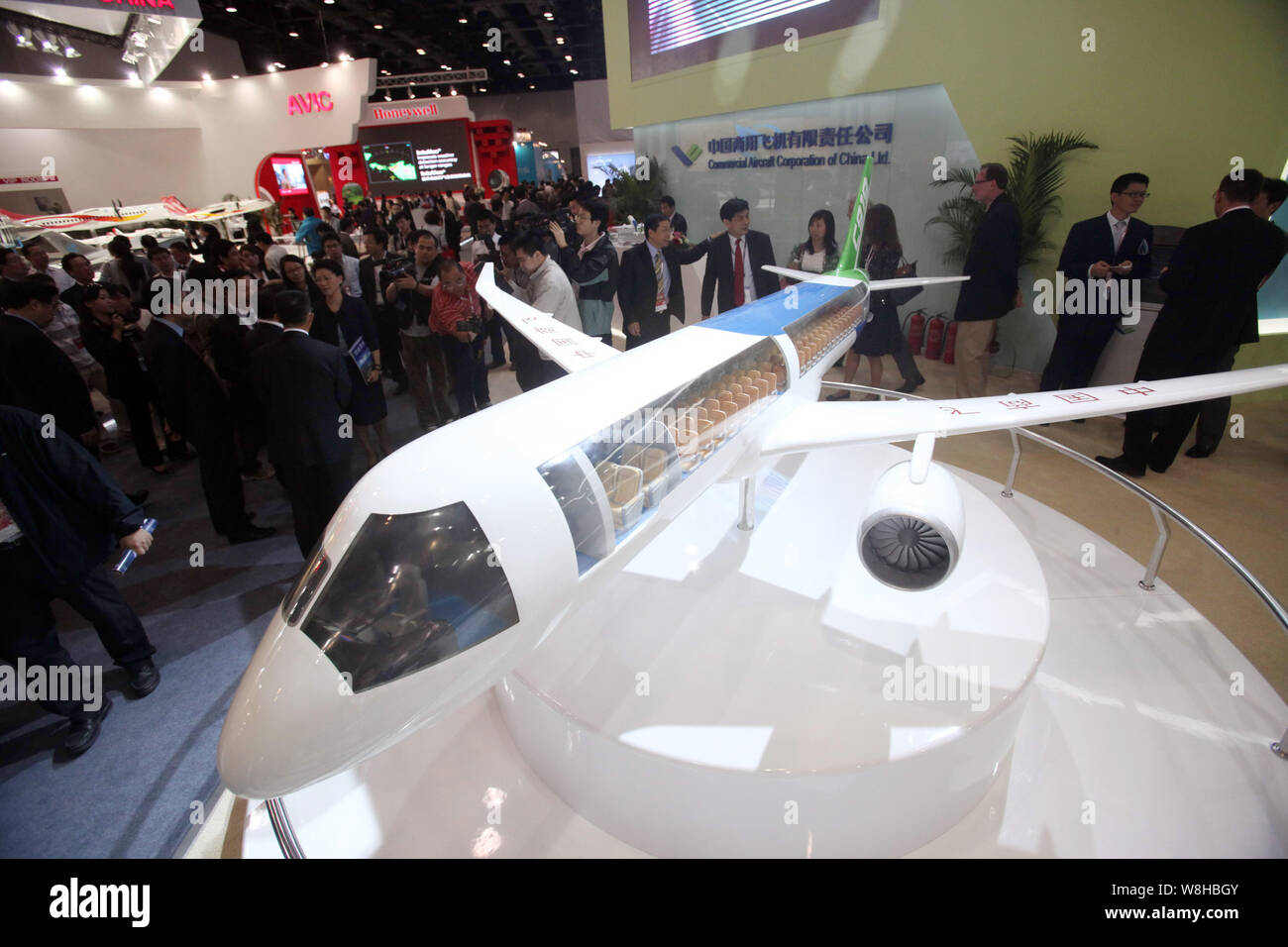 --FILE--Visitors look at a model plane of the C919 on display at the ...