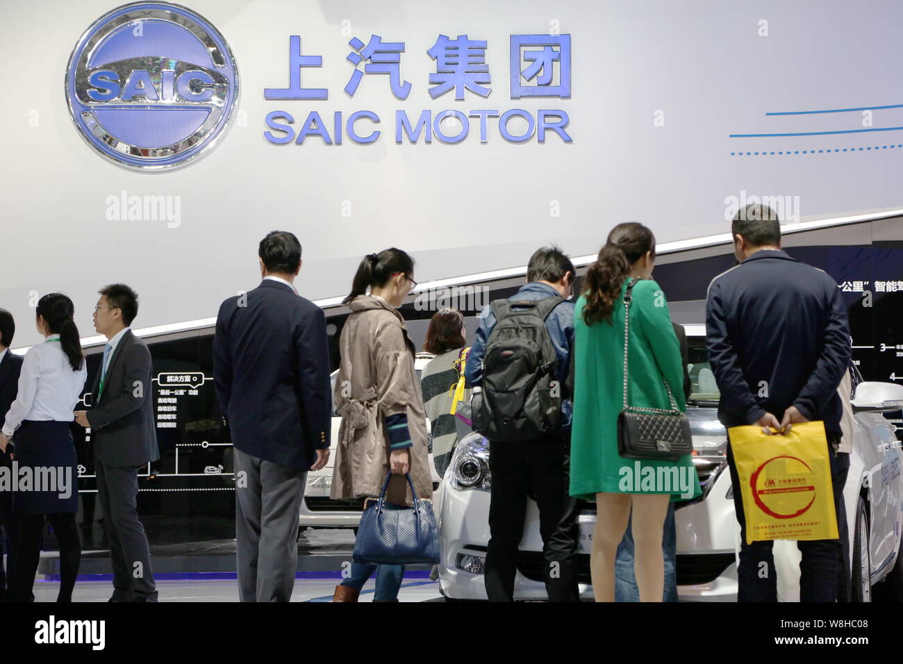 --FILE--Visitors look at electric and hybrid cars of SAIC Motor on ...