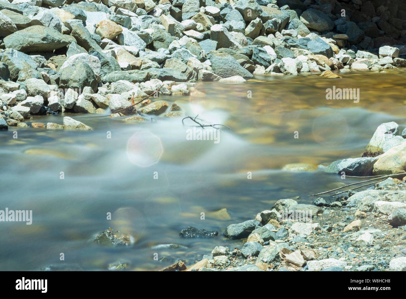 Small rocky river with rocky banks. Smooth flowing water Stock Photo ...