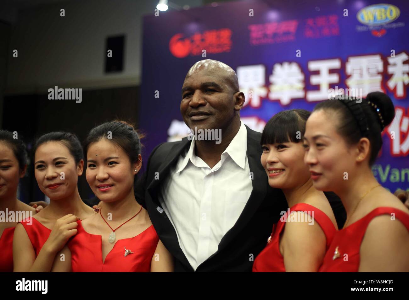 American boxing world champion Evander Holyfield, third right, poses ...