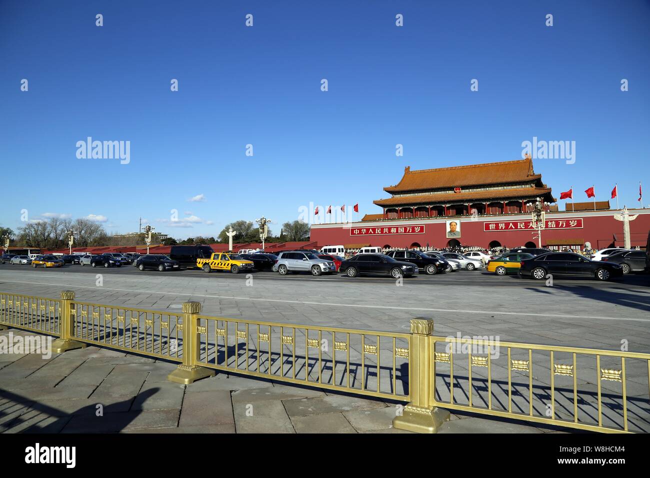 Cars pass by Tiananmen Square under a blue sky after several days of ...