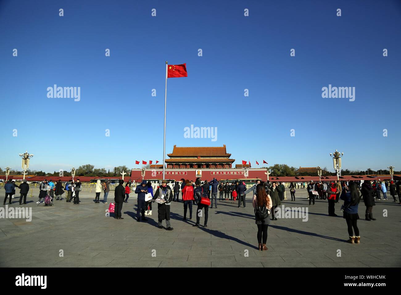 Chinese stands on Tiananmen Square under a blue sky after several days ...