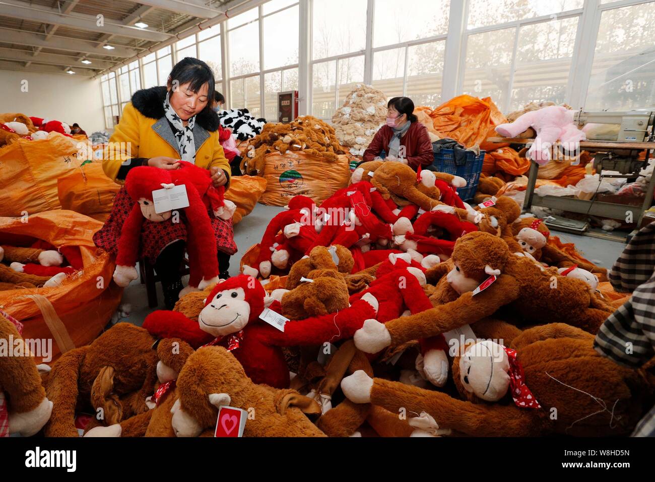 Female Chinese workers sew stuffed toys to be exported to Europe and ...