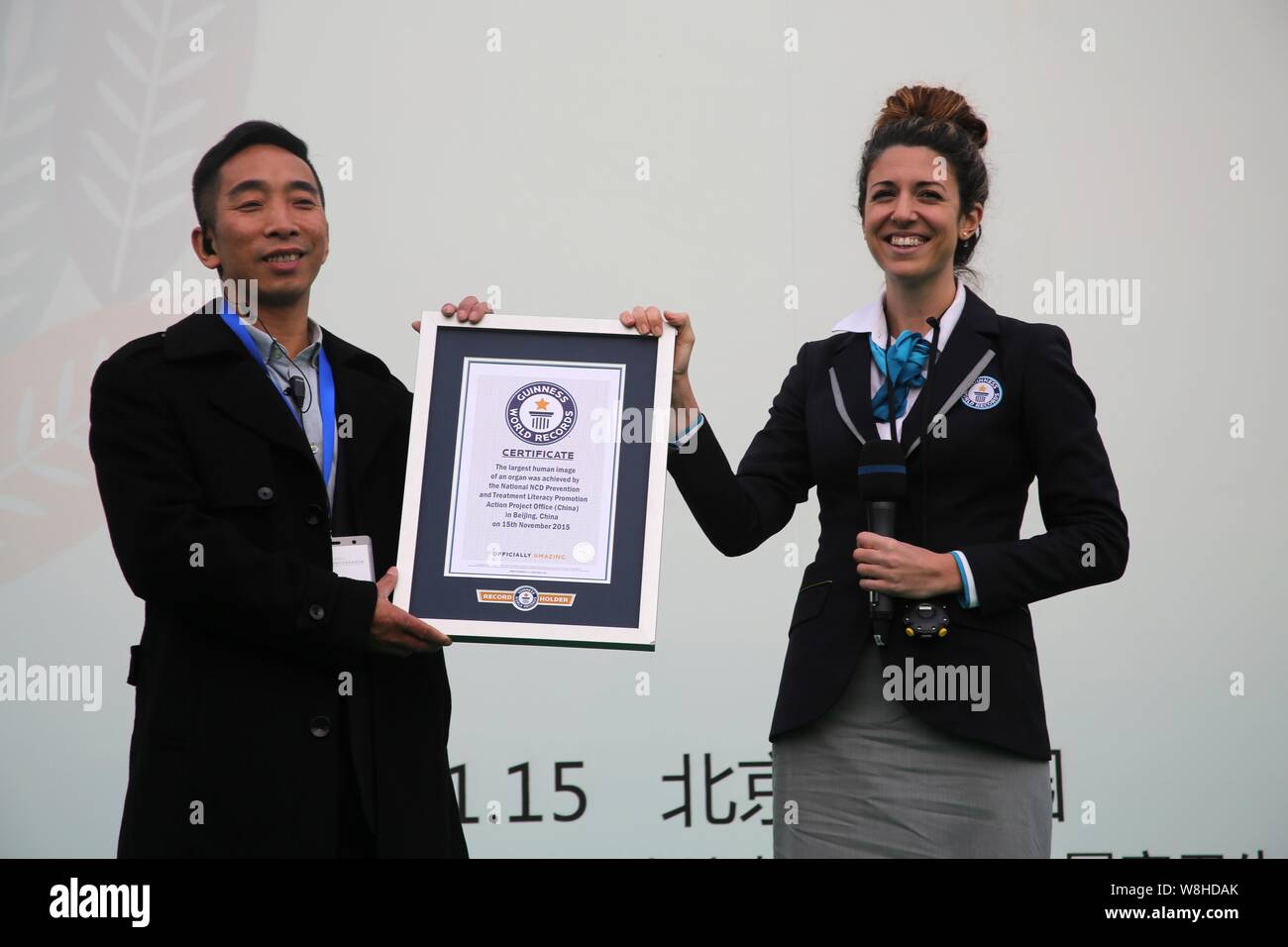 A representative of the organizer, left, shows the certificate for the ...