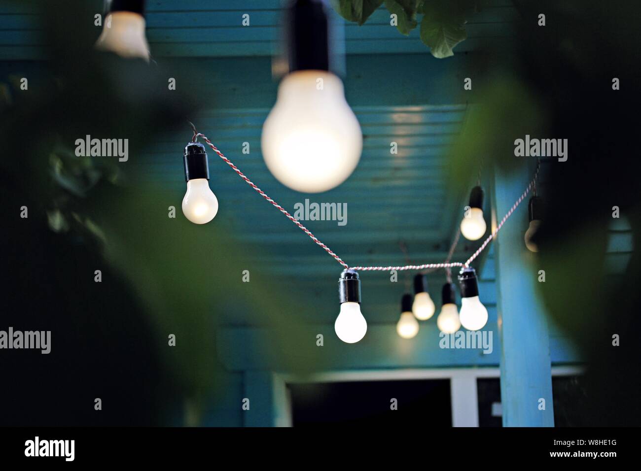 Shot of light bulbs hanging from threads Stock Photo - Alamy