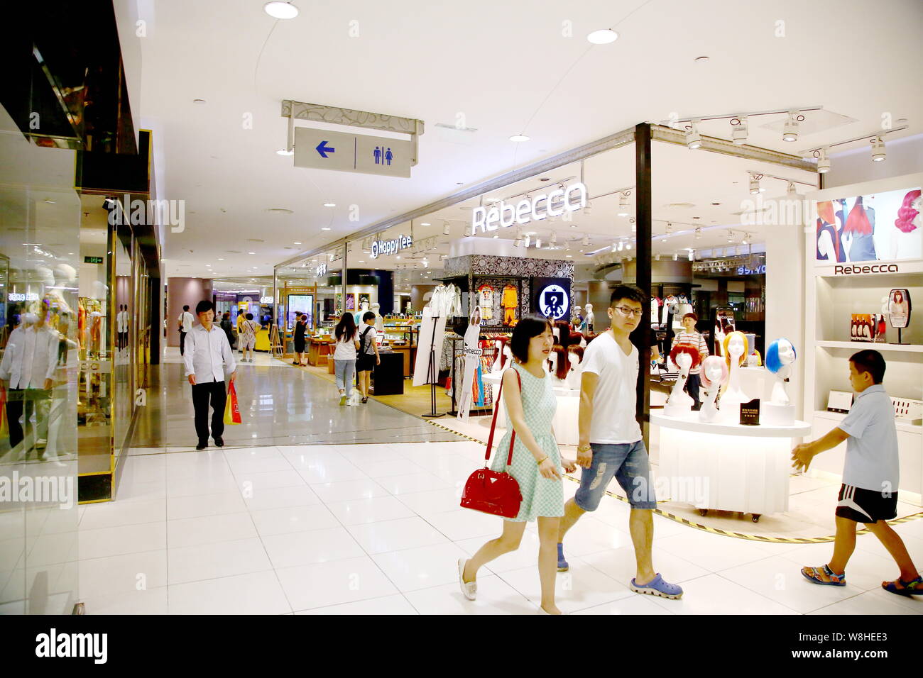 Shoppers walk past stalls and stores at Super Brand Mall in the ...