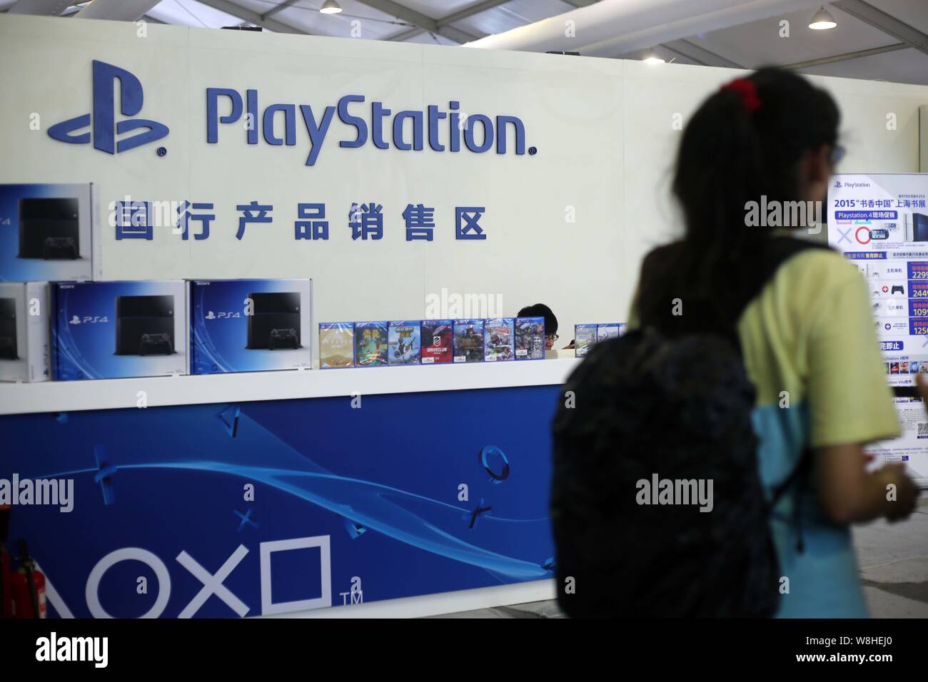 --FILE--A visitor walks past a stand of Sony's PlayStation 4 (PS4 ...