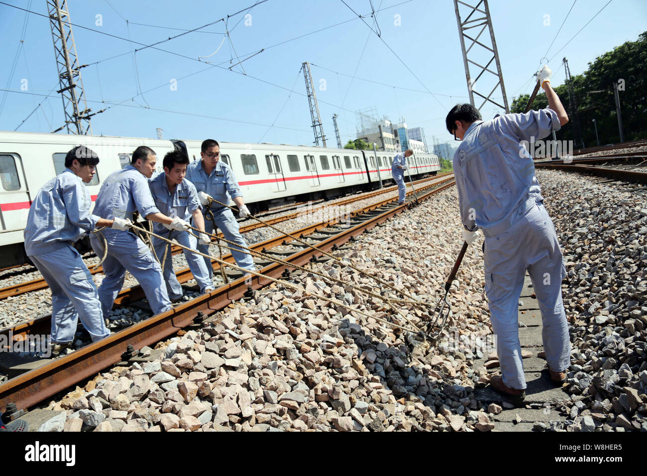 --FILE--Chinese workers pull stones to reinforce the foundation of ...