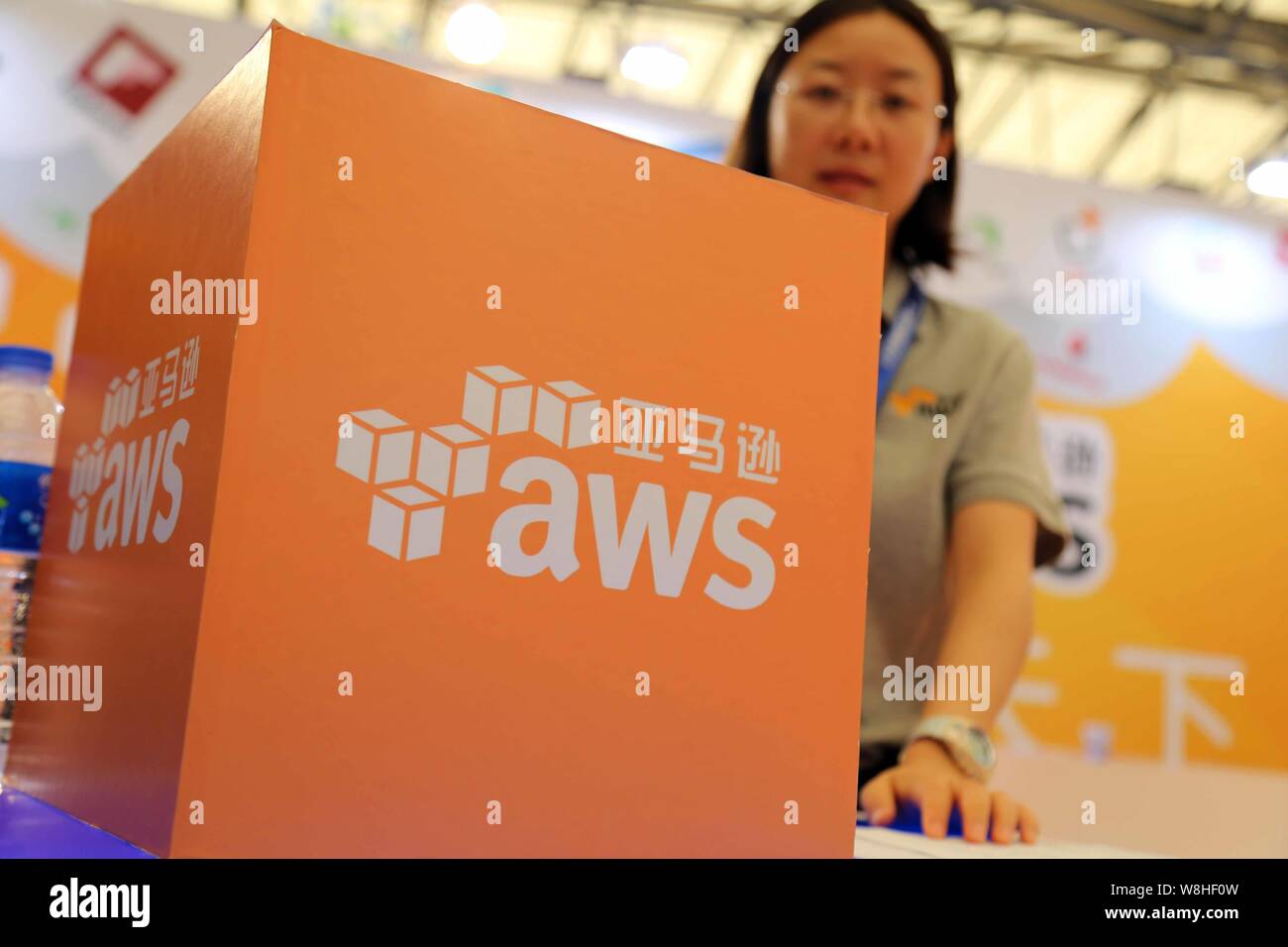 --FILE--A Chinese employee is seen at the stand of AWS (Amazon Web ...
