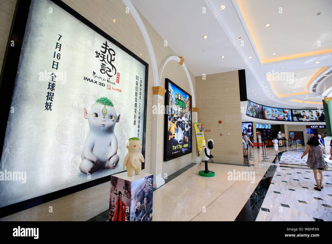 --FILE--A poster for the movie "Monster Hunt" and a model of Wuba, a ...