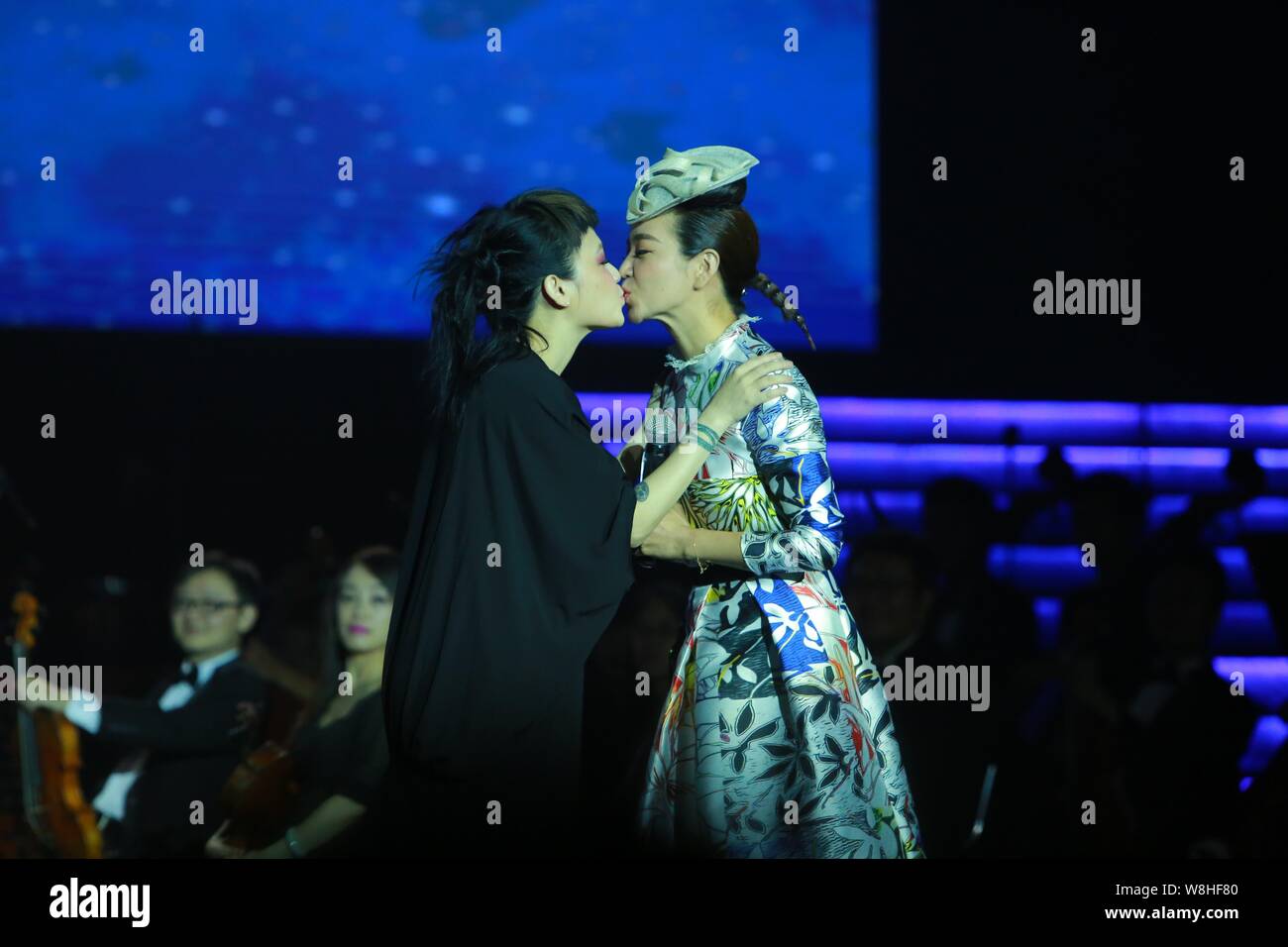 Taiwanese singer Mavis Fan, left, and TV hostess Aya kiss each other at ...