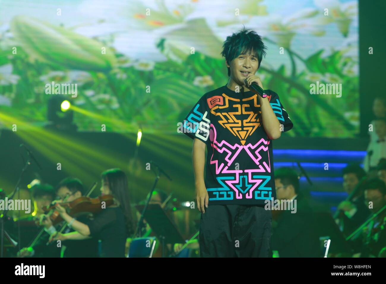 Chinese singer Wowkie Zhang Wei performs at the "one night" charity ...