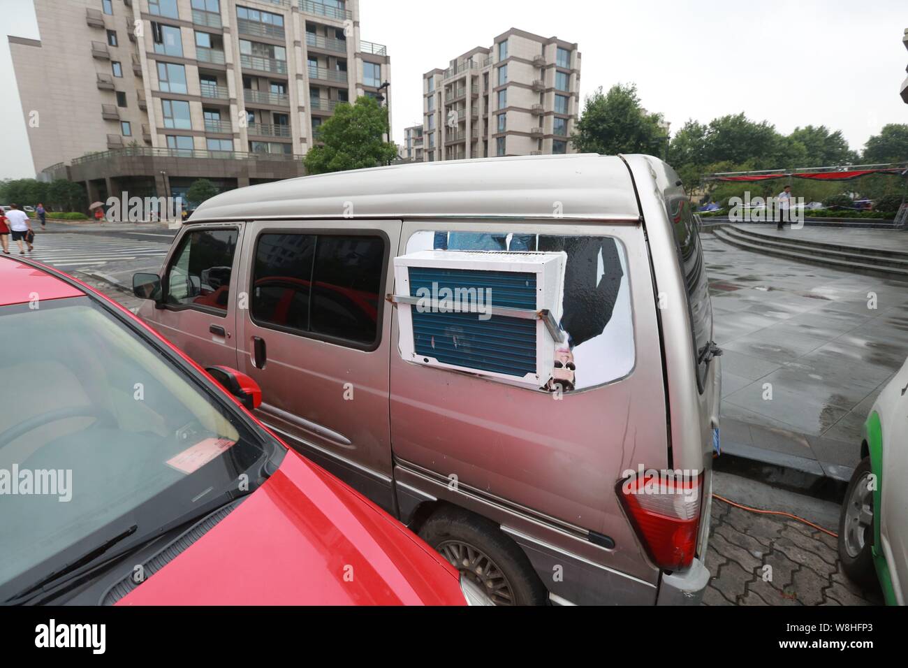 View of a mini-van with an air conditioning unit installed on its left ...