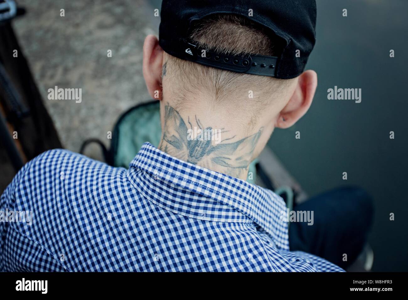 Shot Of A Male With Insect Tattoo On Neck Stock Photo - Alamy