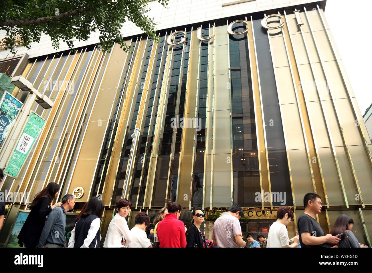 Customers queue up in front of a Gucci store at a shopping mall in ...