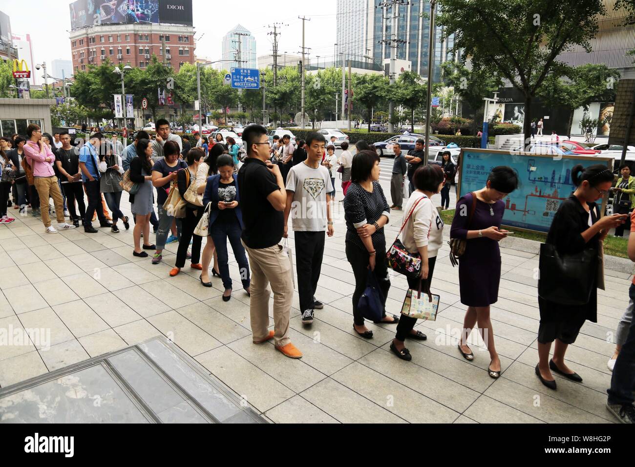 Customers queue up in front of a Gucci store at a shopping mall in ...