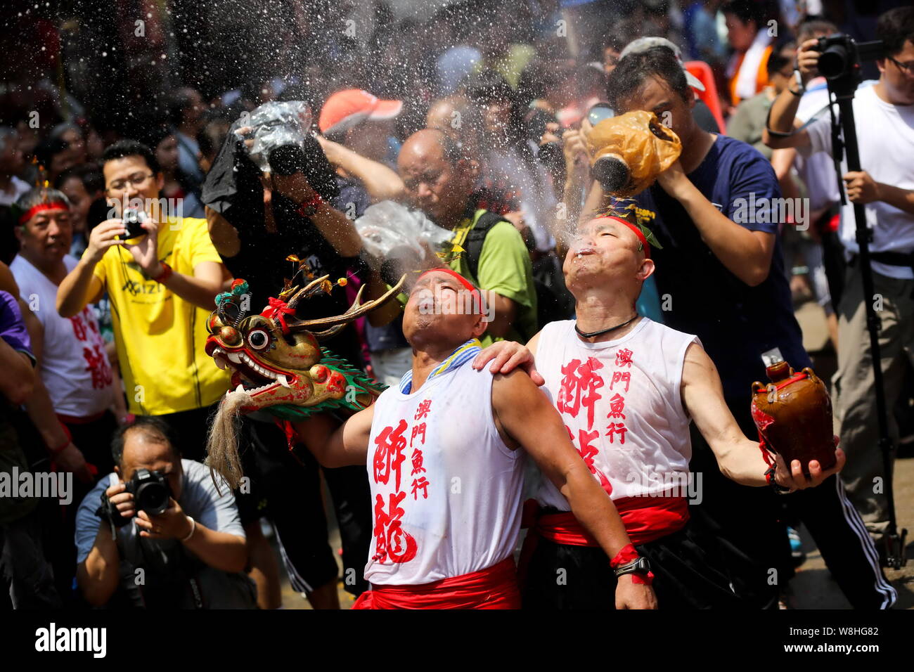 Performers spray beer from their mouths to perform a drunken dragon ...