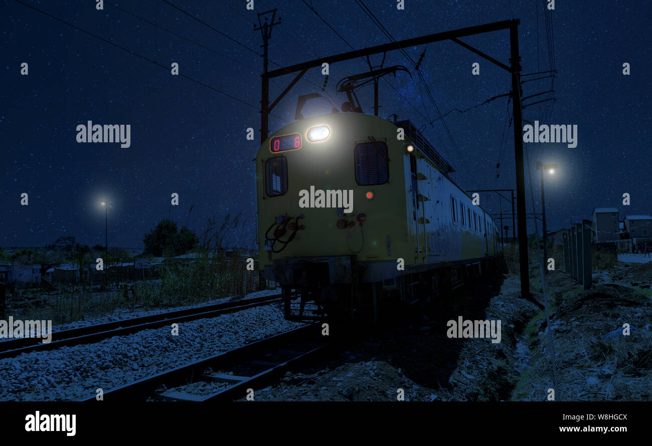 Commuter Train moving through the heart of Soweto Township at night ...