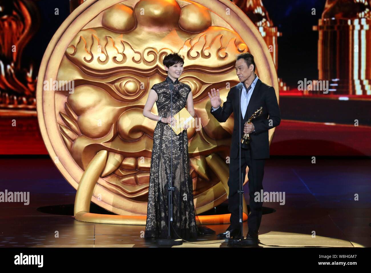 Chinese actress Xu Fan, left, and actor Wang Xueqi announce the winner ...