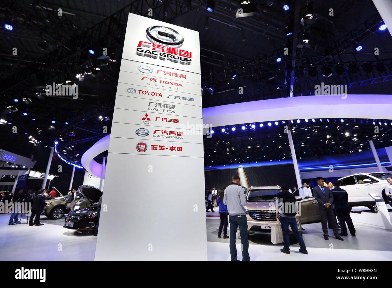 --FILE--Visitors look at cars on display at the stand of GAC Group ...