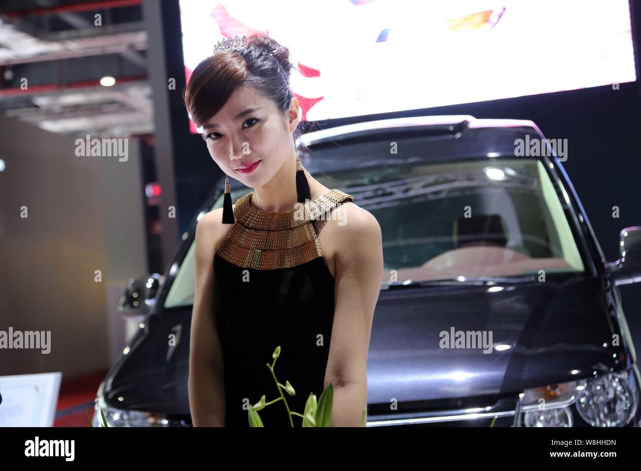 A hostess poses during the 16th Shanghai International Automobile ...