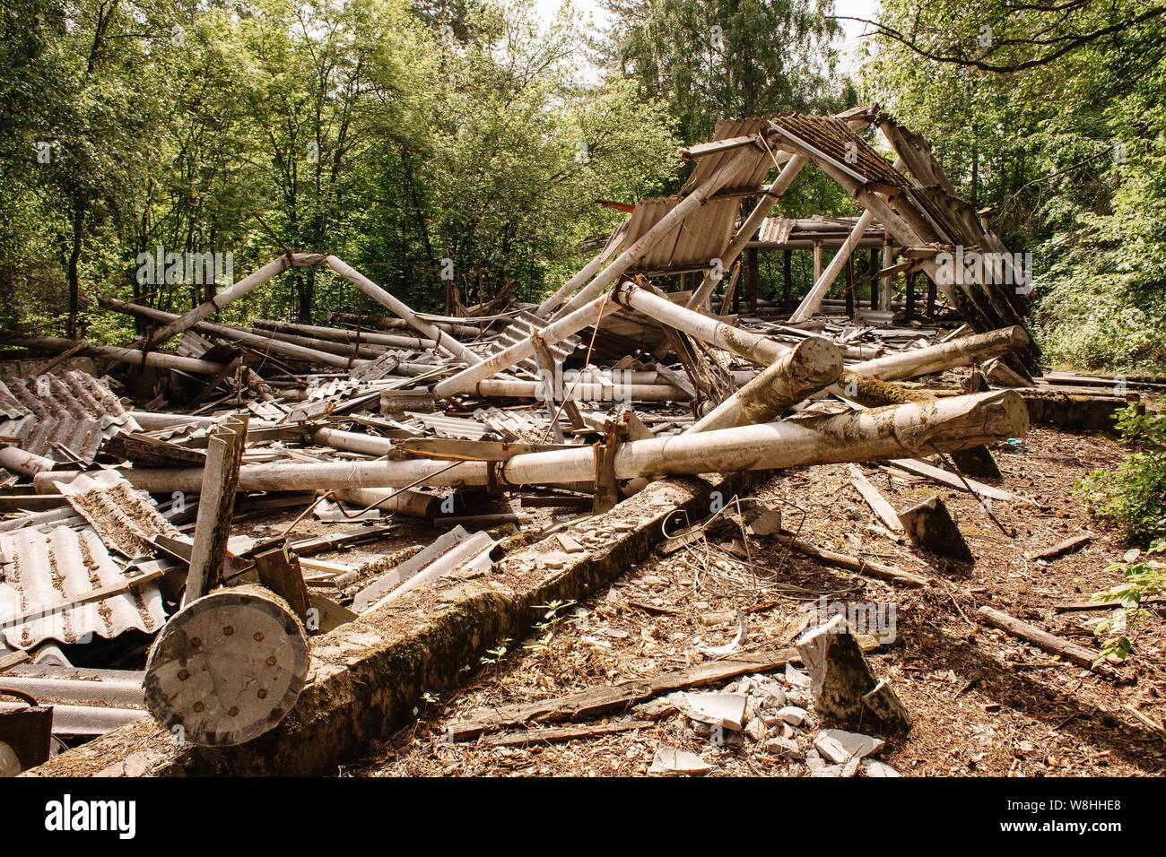 Dilapidated building with reinforced concrete columns and broken slate ...