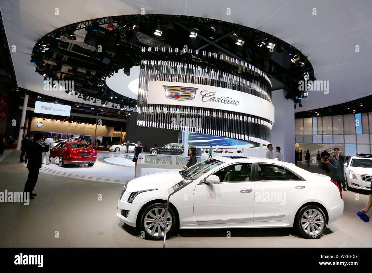 Visitors look at Cadillac cars on display during the 16th Shanghai ...