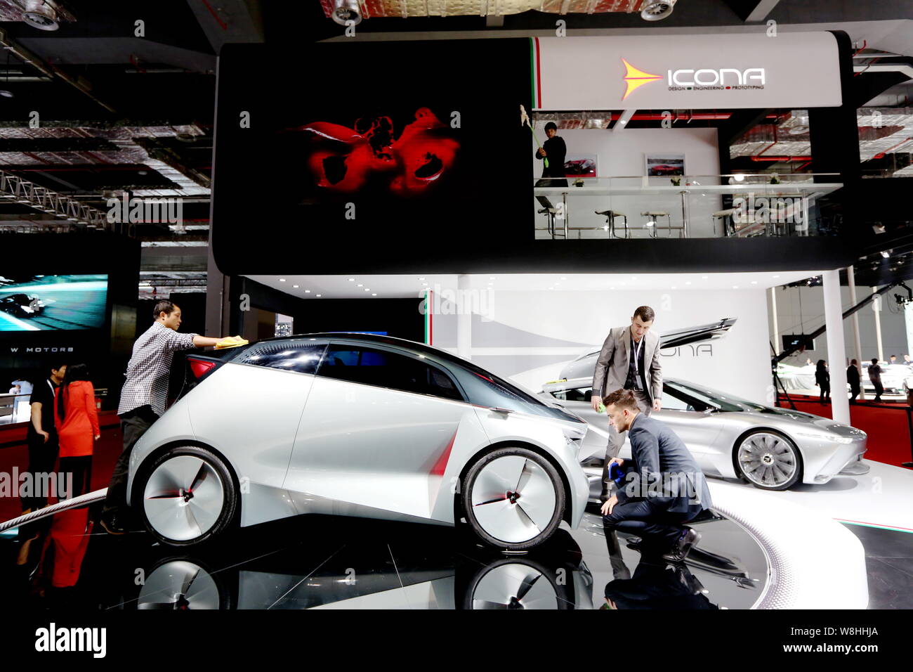 Workers dust off a concept car of ICONA on display during the 16th ...