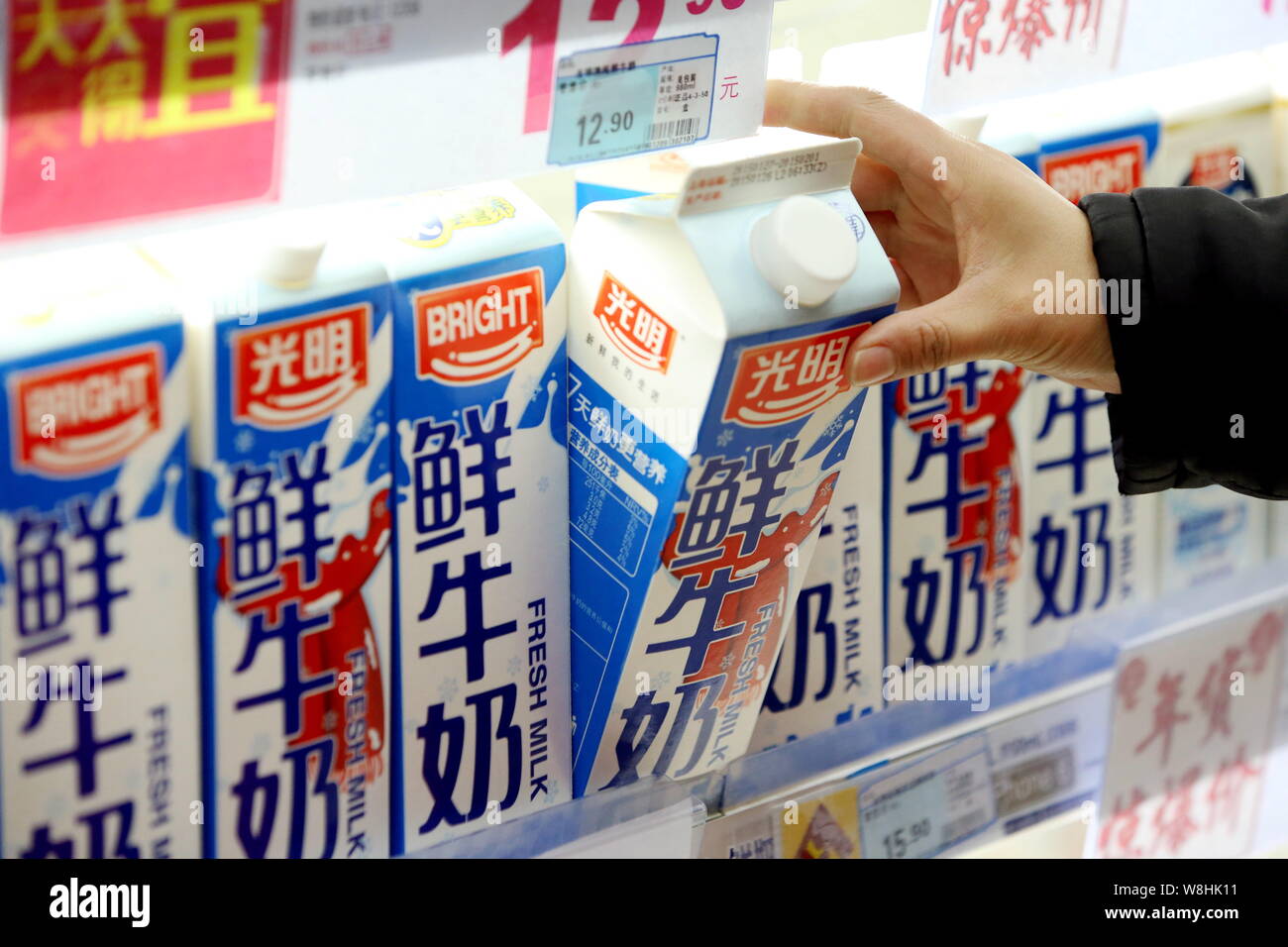 --FILE--A customer buys a carton of Bright Dairy's fresh milk at a ...
