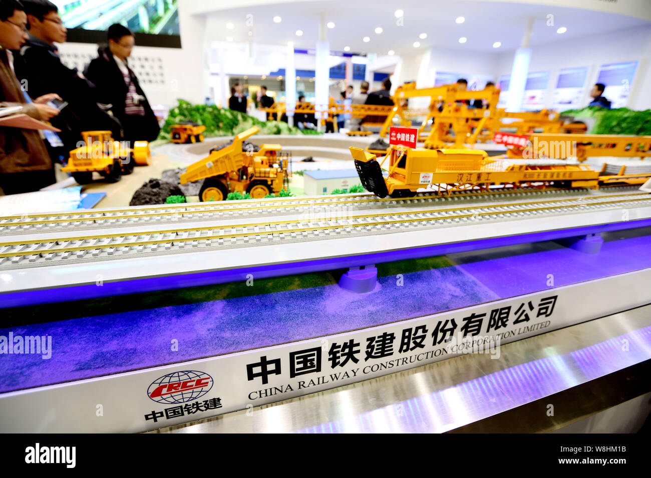 --FILE--Visitors look at models of railway construction machines at the ...