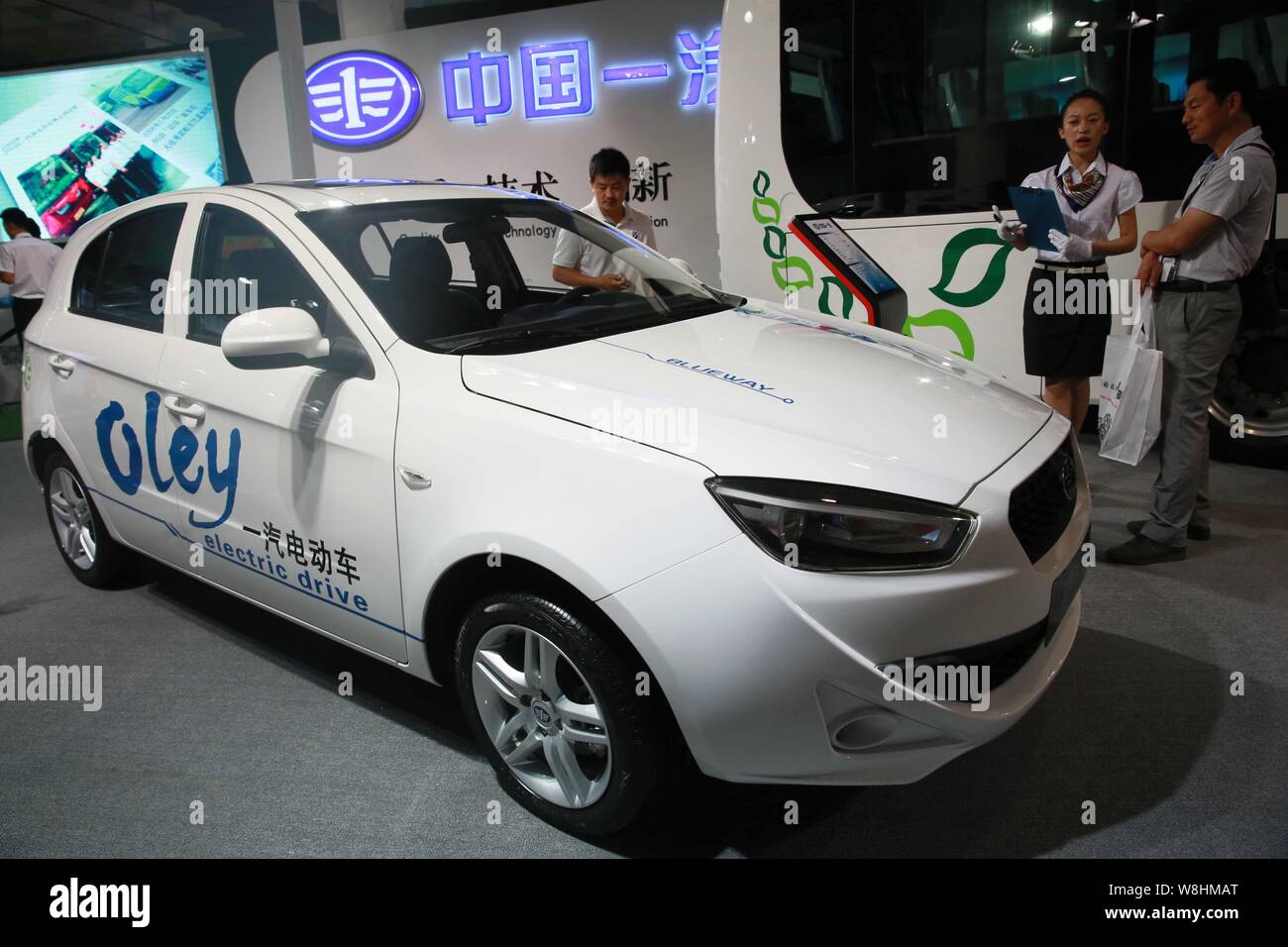 --FILE--Visitors look at an Oley electric car of FAW Group during an ...