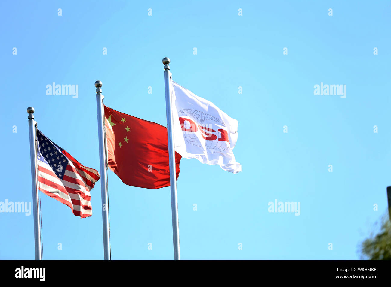 --FILE--Flags of the United States, China and OSI Group LLC flutter at ...