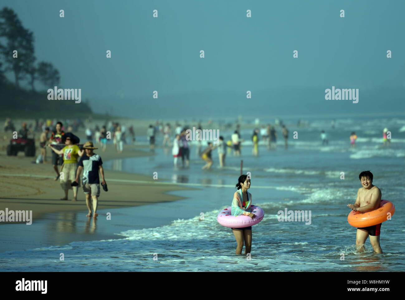 Tourists have fun at a beach resort during the Chinese Lunar New Year ...