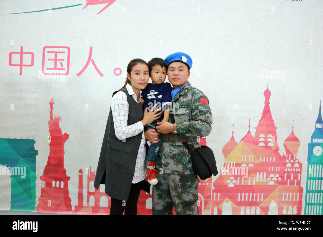 --FILE--A Chinese family of three poses for a photo at the Zhengzhou ...