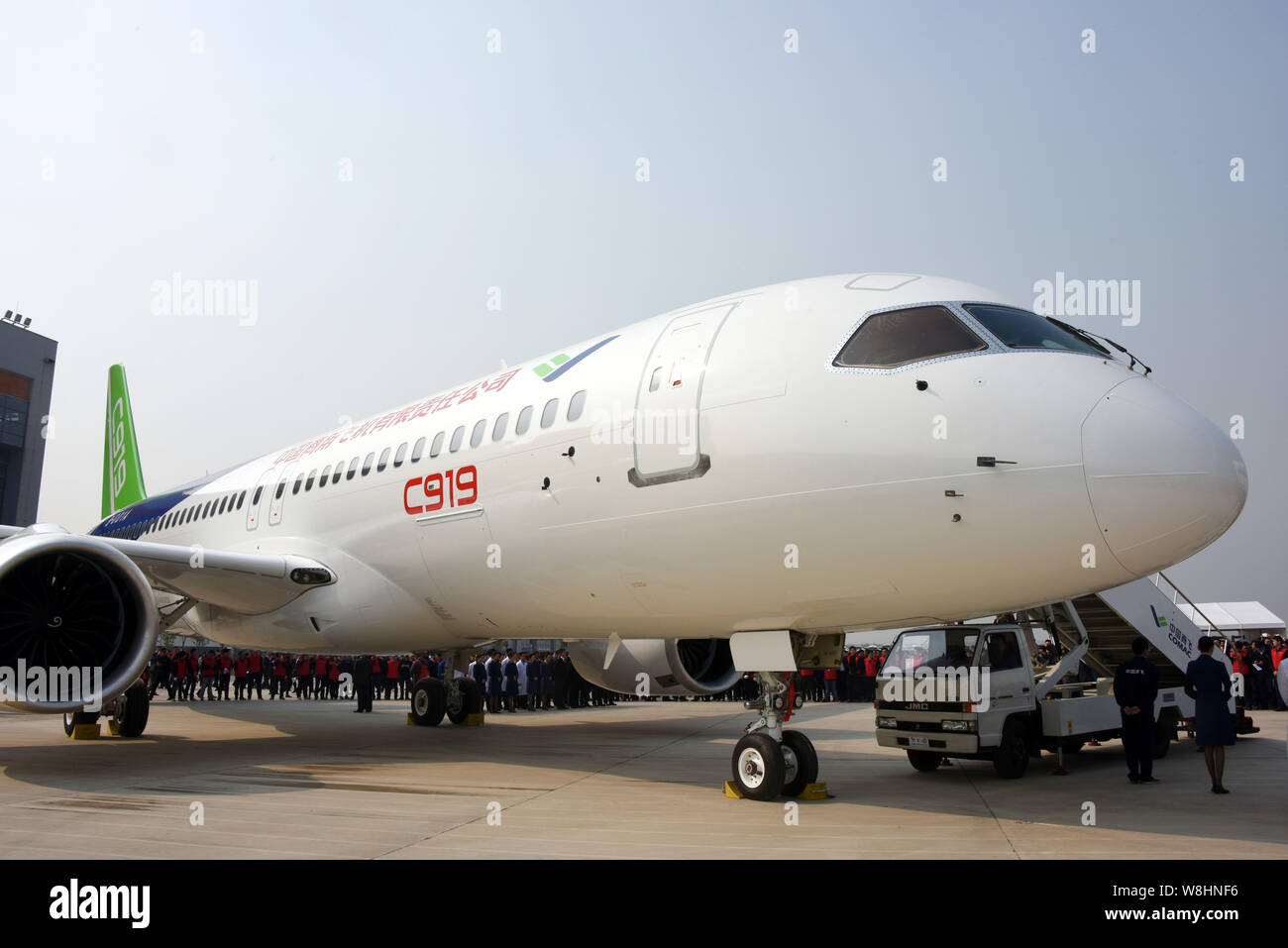 People stand around China's first homemade large passenger jet C919 ...