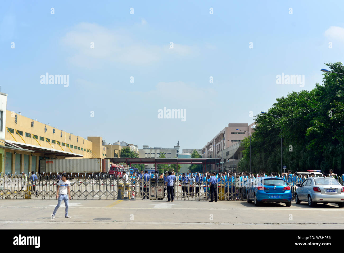 Chinese workers crowd at the entrance of the factory of Kinpo ...